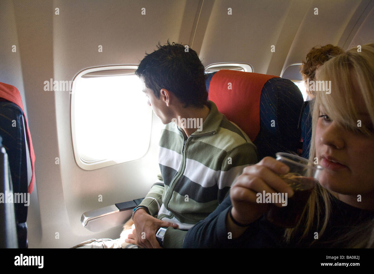 Passenger looking through window in cabin Ryanair Boeing 737 800 ...