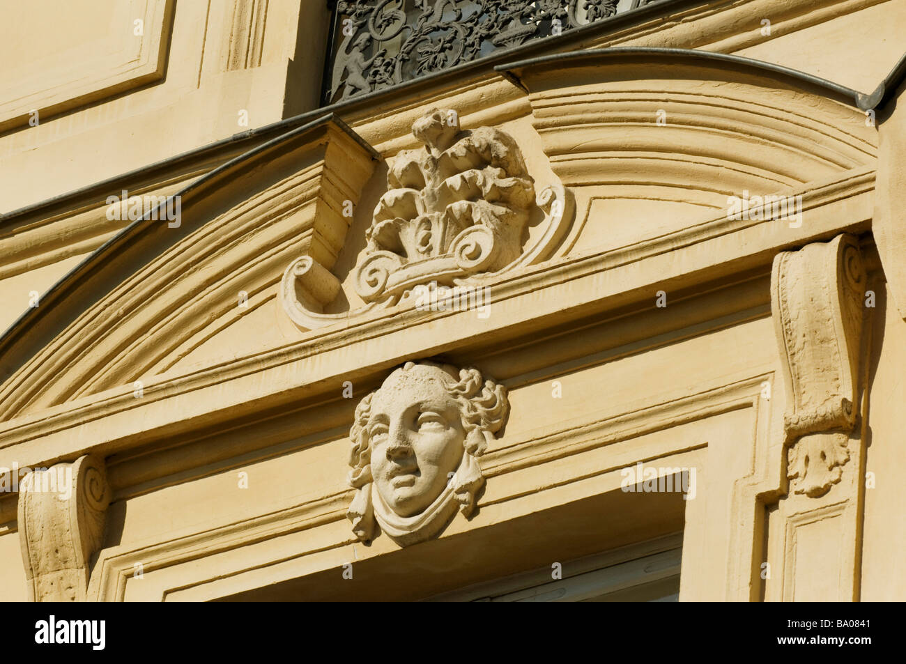 Railing, architectural detail of a woman's face and door arch on the ...