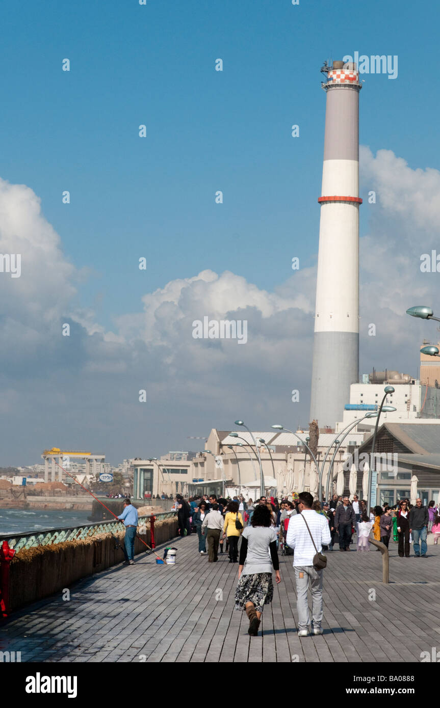 Boardwalk of the Old Tel Aviv Port area and chimney of Reading power ...