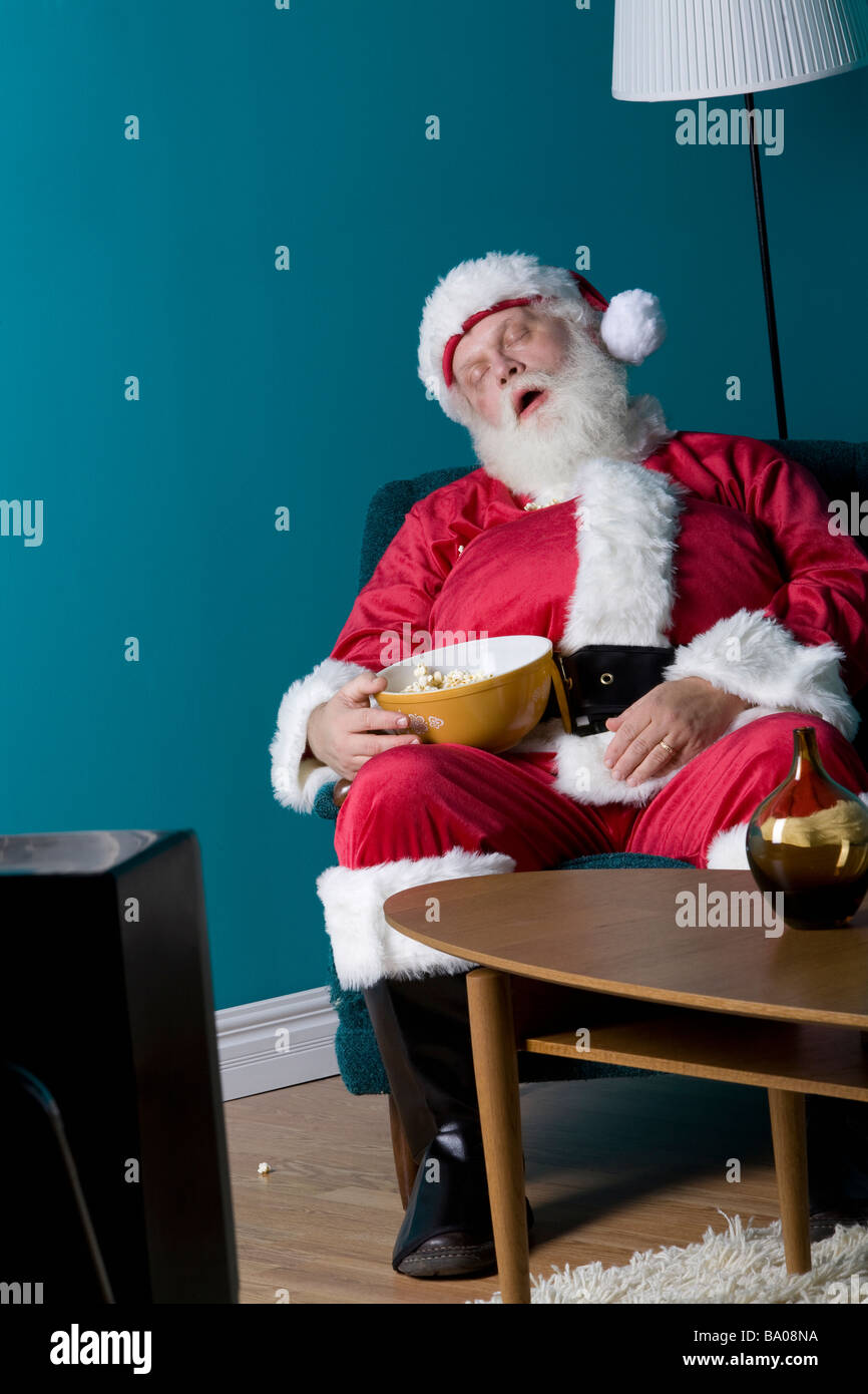 Santa sitting and sleeping Stock Photo - Alamy