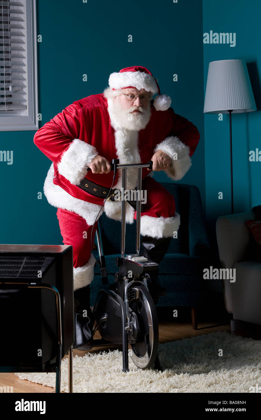 Santa riding stationary bike Stock Photo - Alamy