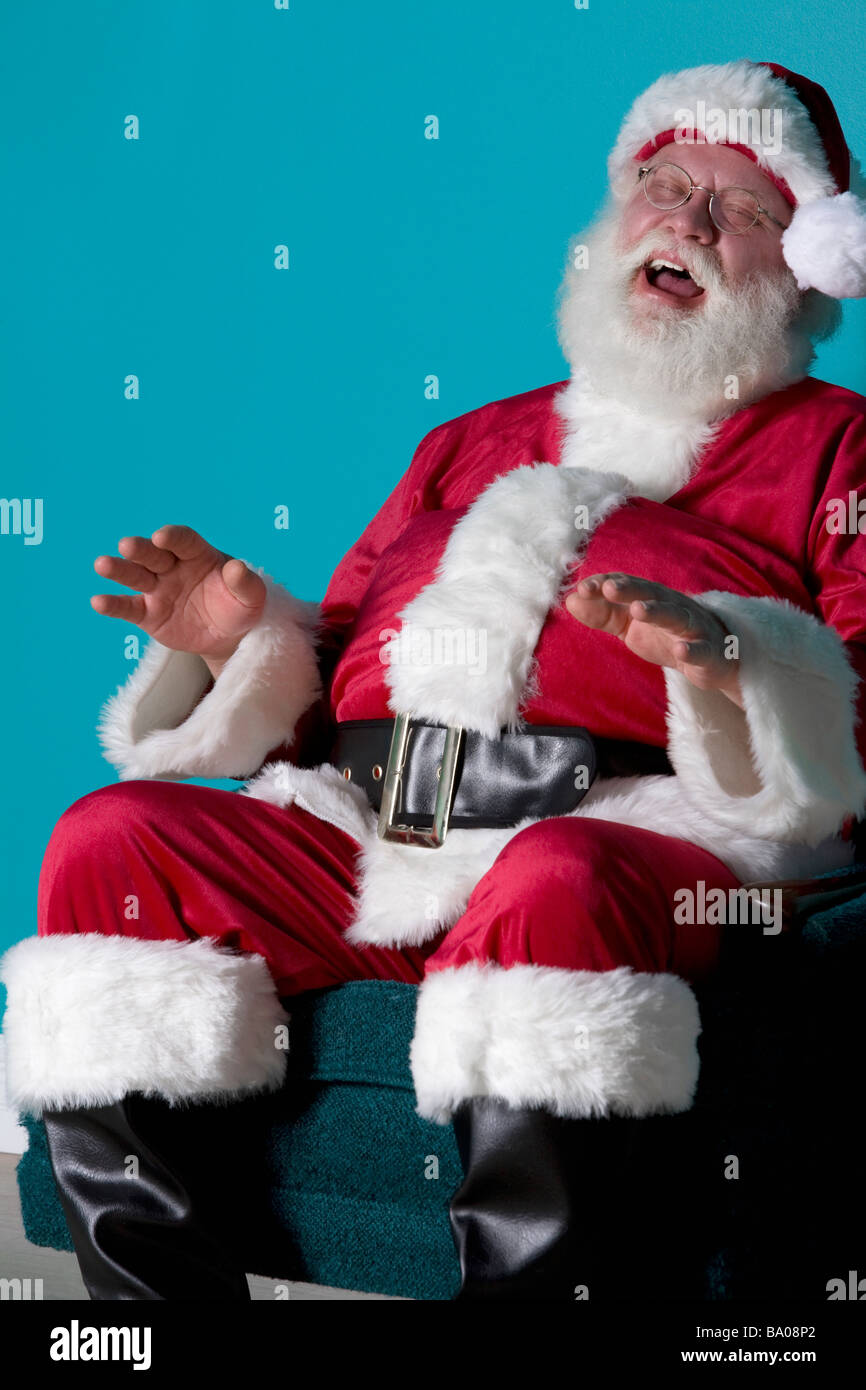 Santa sitting and laughing Stock Photo - Alamy