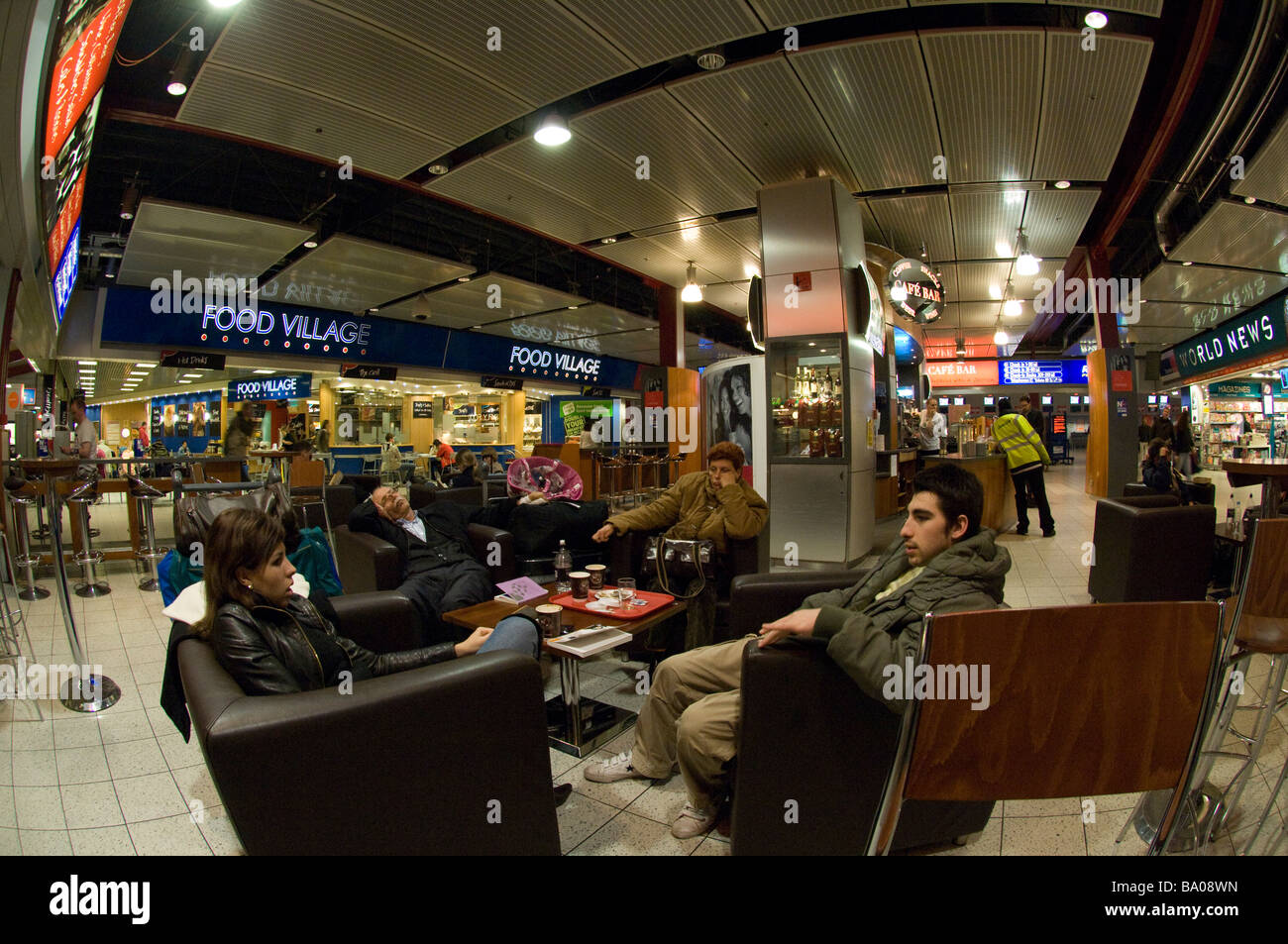Passengers waiting in lounge Food village departures Luton Airport ...