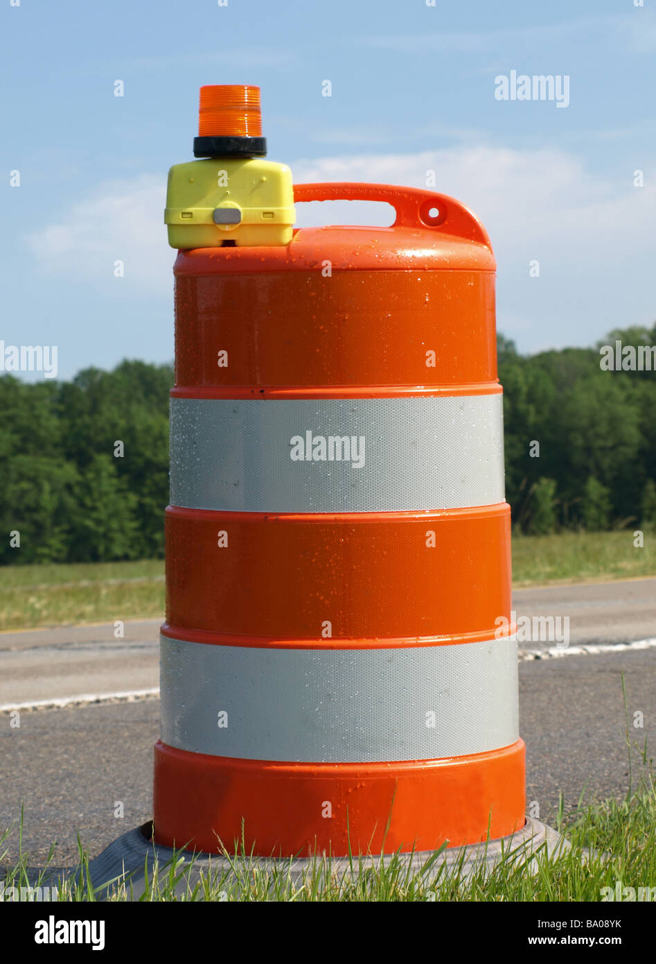 Construction barrel that is orange and white at highways edge Stock ...