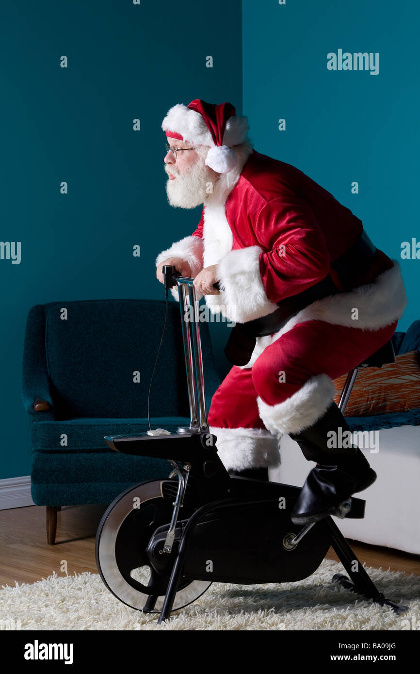 Santa riding stationary bike Stock Photo - Alamy