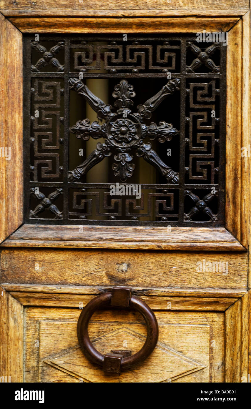 Architectural detail of a door window and knocker in the Latin Quarter ...