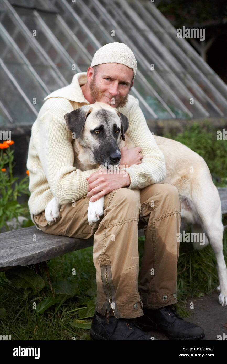 man and his dog next to a greenhouse Stock Photo - Alamy