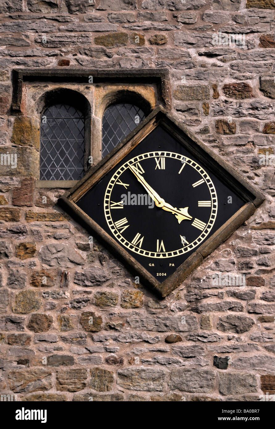 Strangely positioned, diamond shaped clock on tower. Church of Saint ...