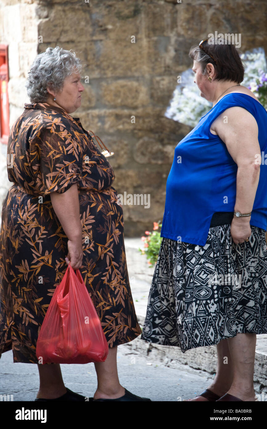 Local residents chatting at the weekly market in Piazza del Duomo, San ...