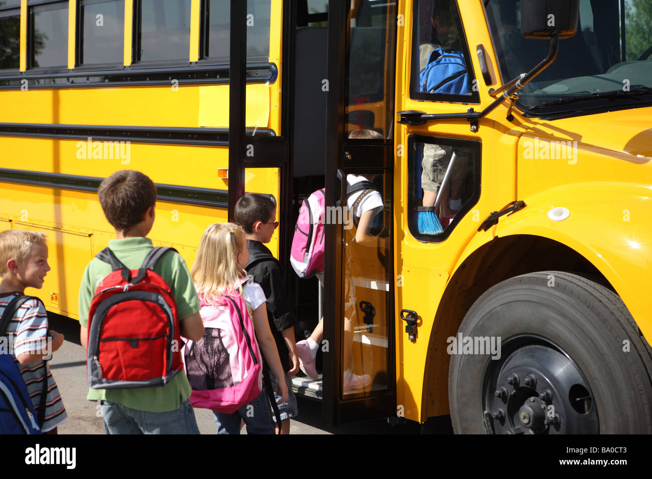 Children getting on school bus Stock Photo - Alamy