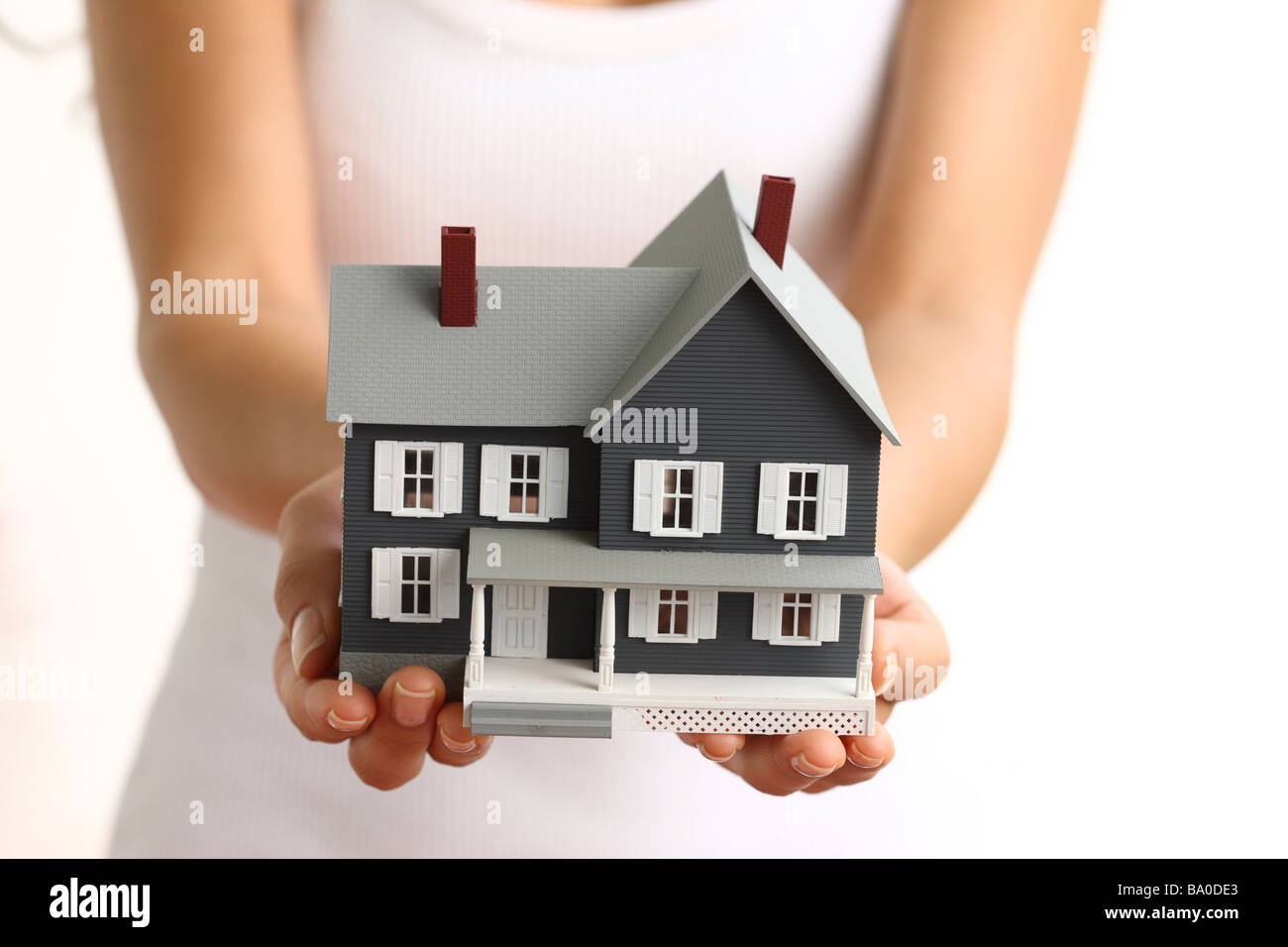 Hands holding small house Stock Photo - Alamy