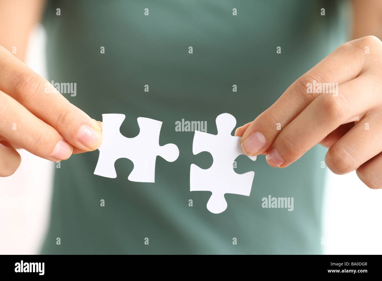 Hands holding two matching puzzle pieces Stock Photo - Alamy