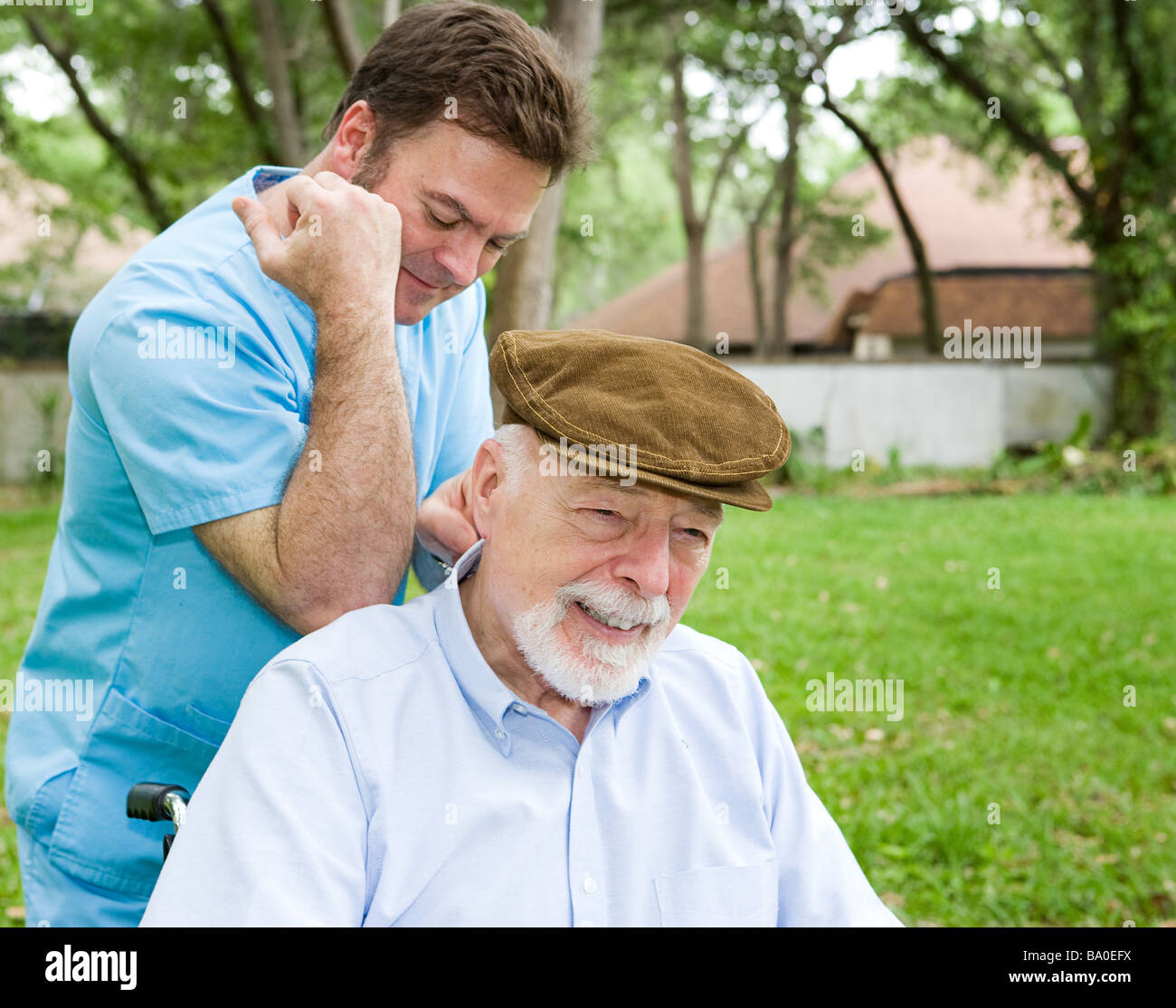 Massage therapist massaging a senior man s back in a beautiful outdoor ...