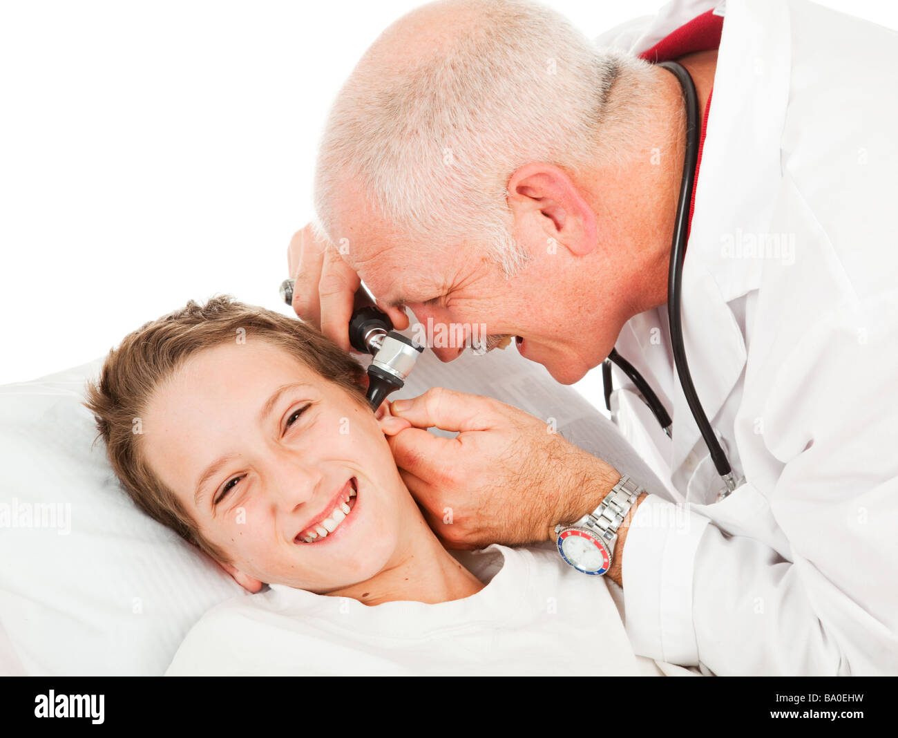 Little boy laughing as the doctor looks in his ear Isolated on white ...
