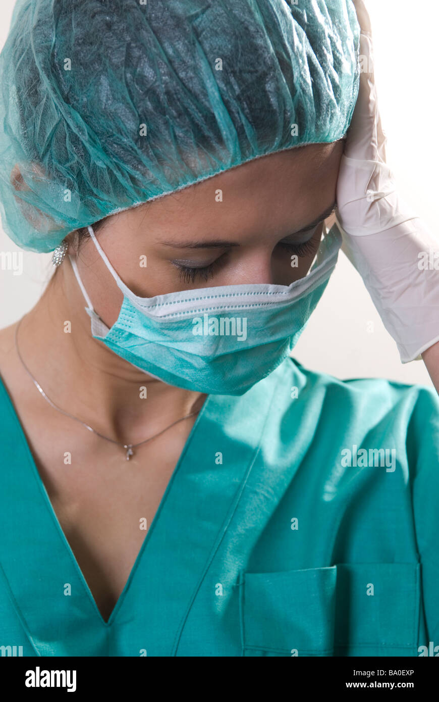 Tired nurse head in hand Stock Photo - Alamy