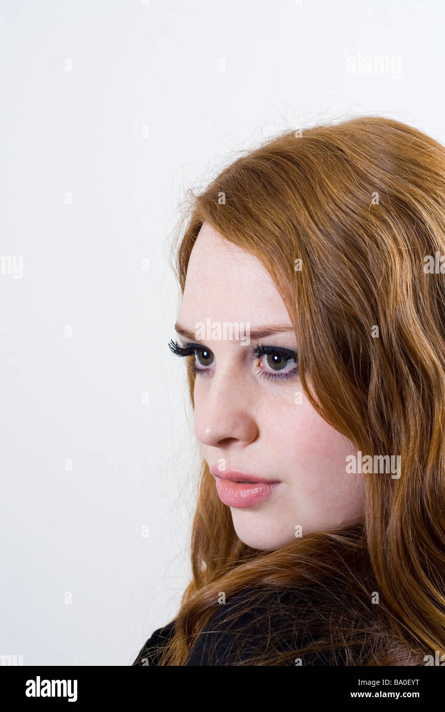 Beautiful young woman looking over shoulder Stock Photo - Alamy