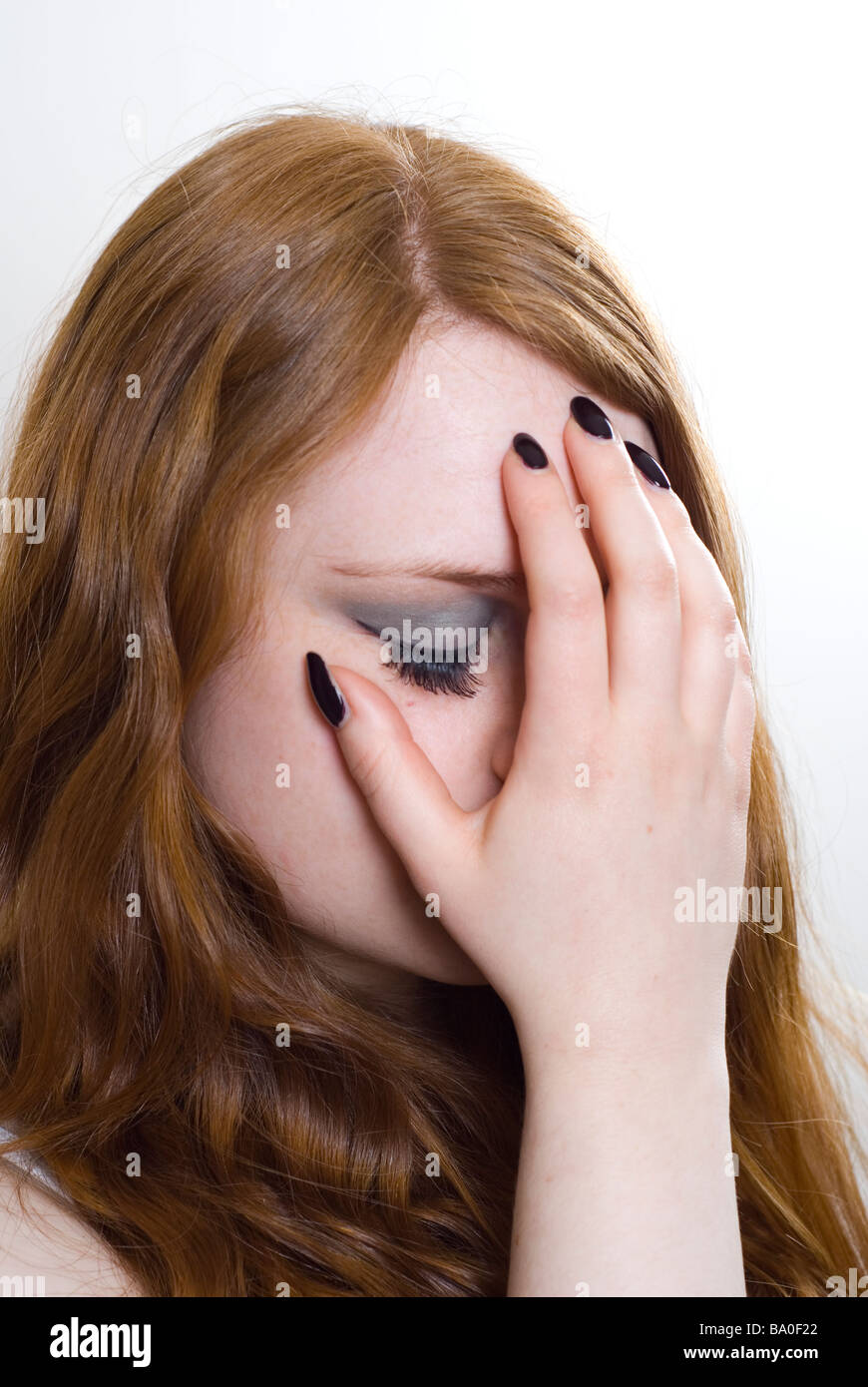 Sad young woman hand over face Stock Photo - Alamy