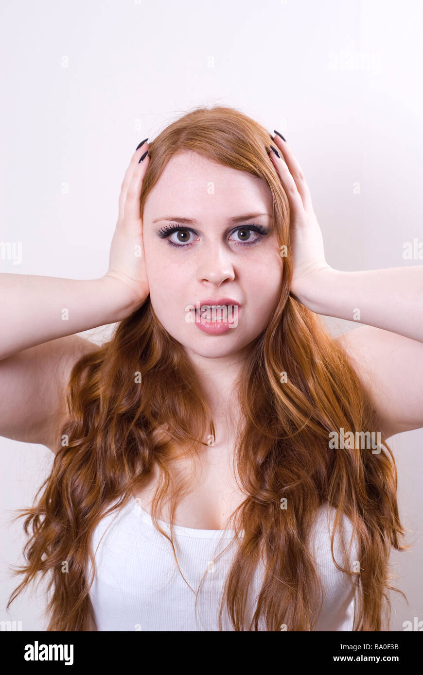 Young woman hands covering ears Stock Photo - Alamy