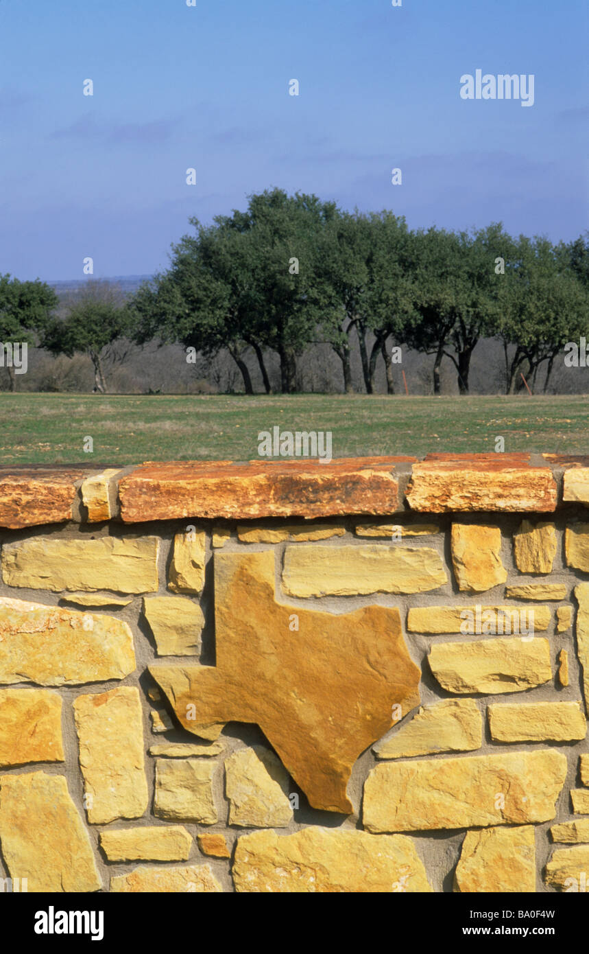 Texas shaped sandstone sign at ranch wall at FM 500 highway near San ...