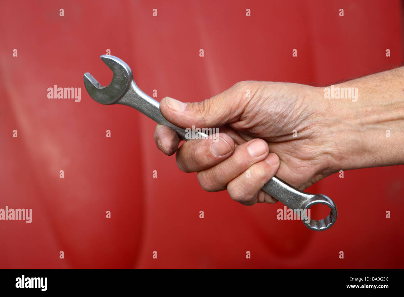 Hand holding wrench Stock Photo - Alamy
