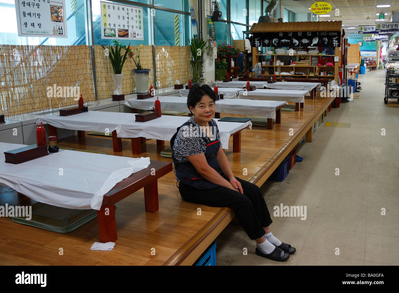 A small traditioanl Korean fresh seafood restaurant owner at the fish ...