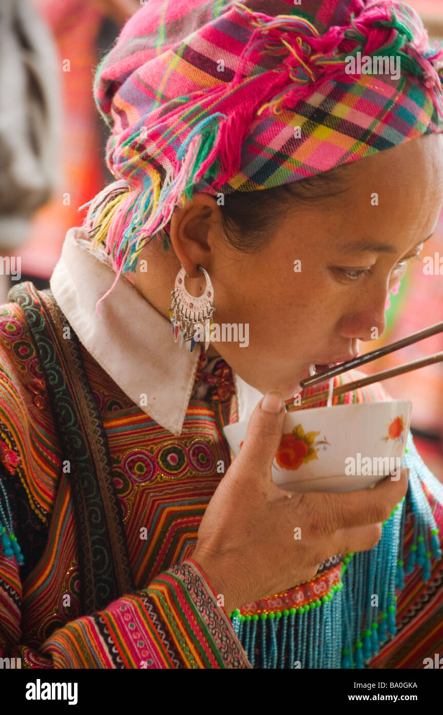 colorful Flower Hmong woman eating lunch in the market in Cau Son near ...