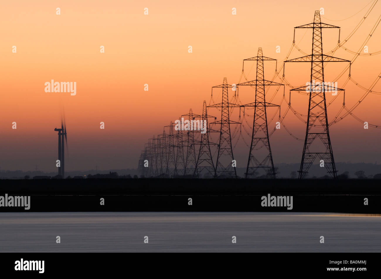 Wind turbines and power pylons and lines Romney Marsh Kent UK Stock ...