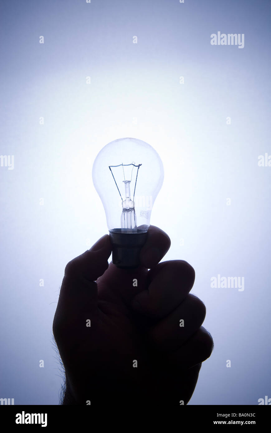 Hand holding a lightbulb Stock Photo - Alamy