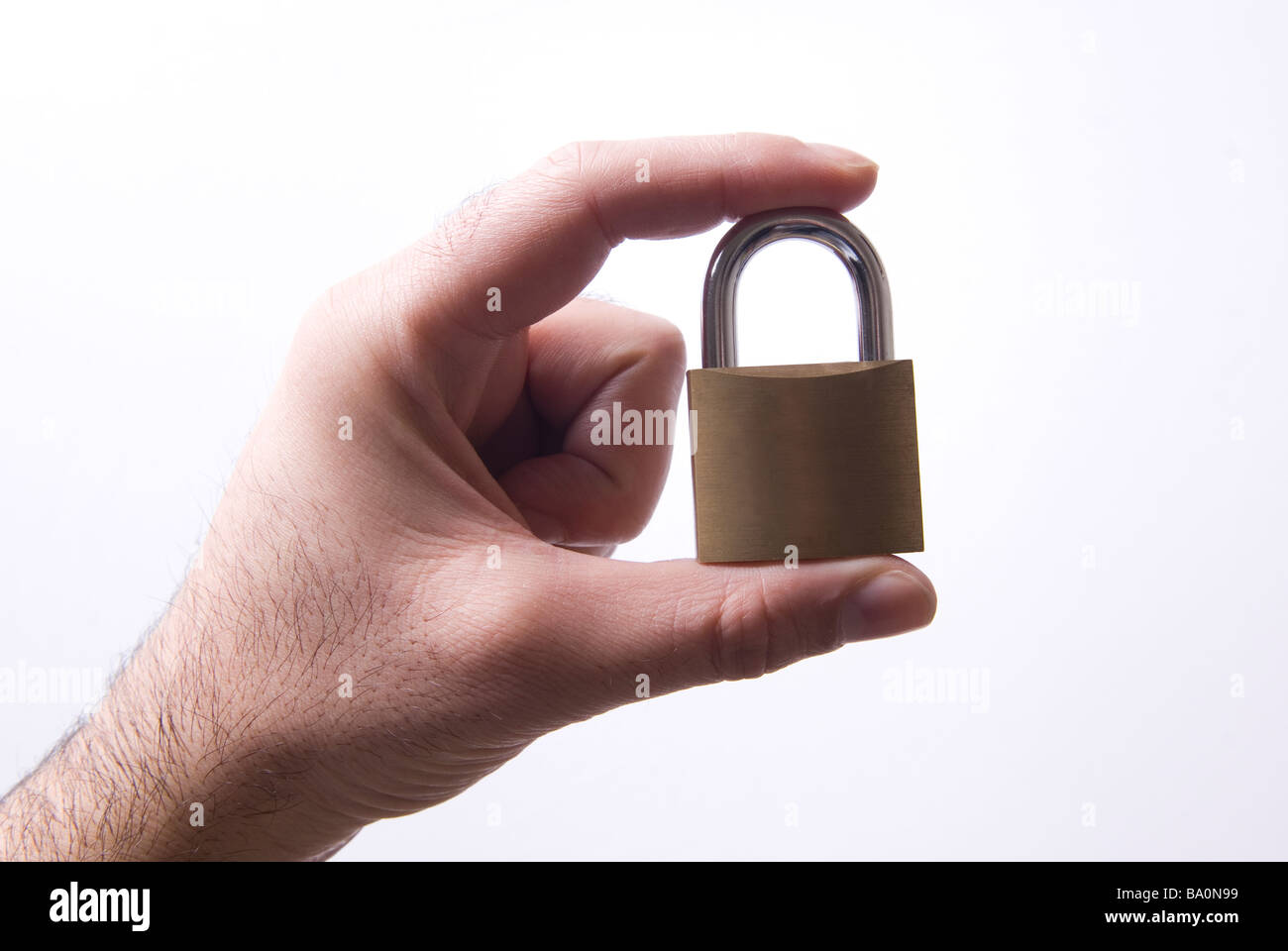 Hand holding a padlock against a white background Stock Photo - Alamy