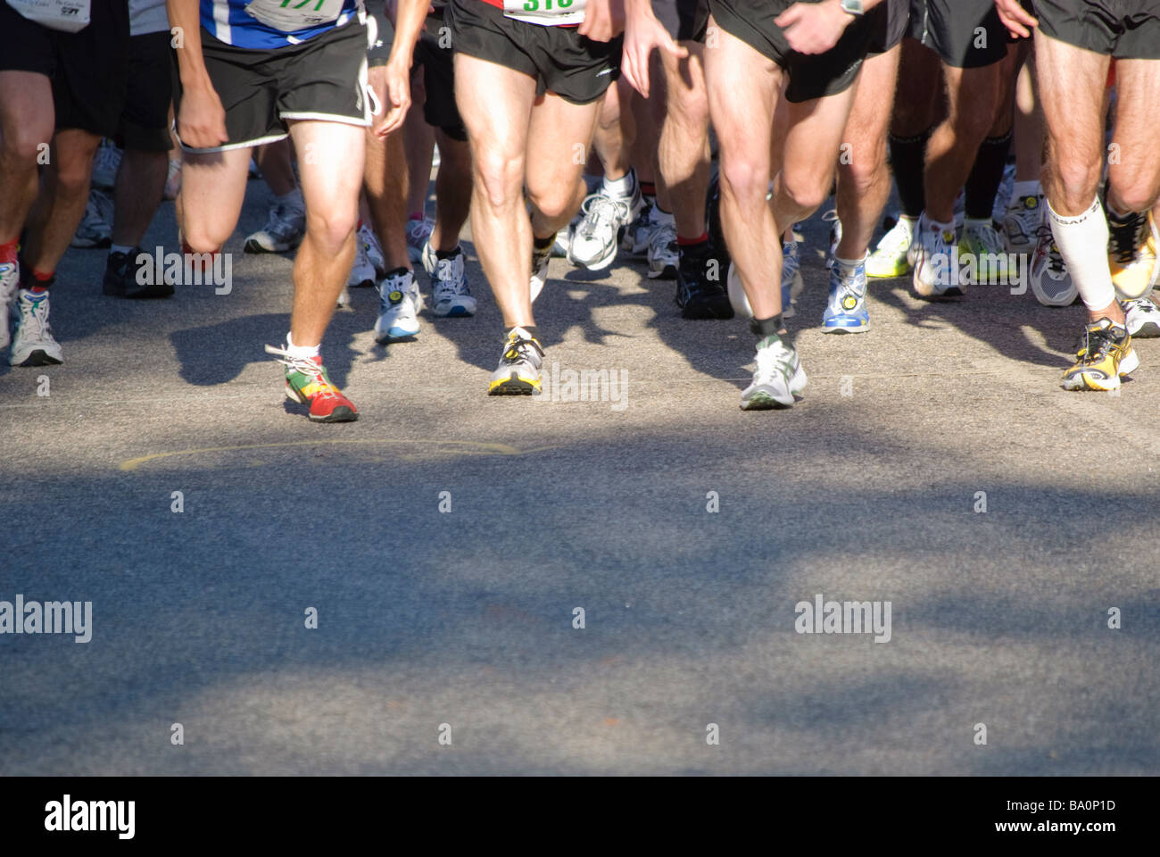 Legs of the front runners at the starting line of the Cary 10k Road ...