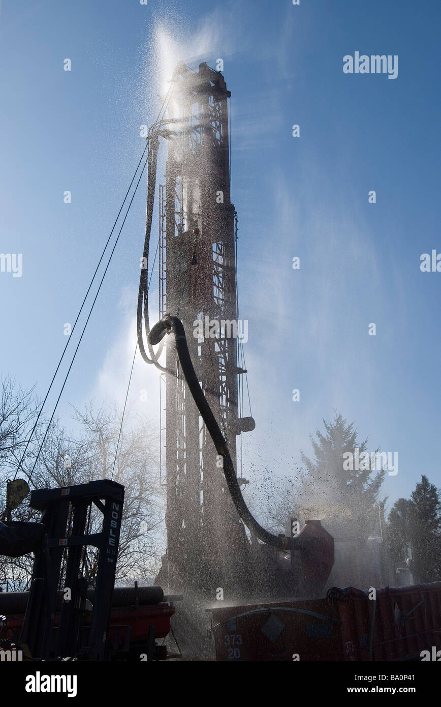 Water spraying out of air rotary drilling rig during water well ...