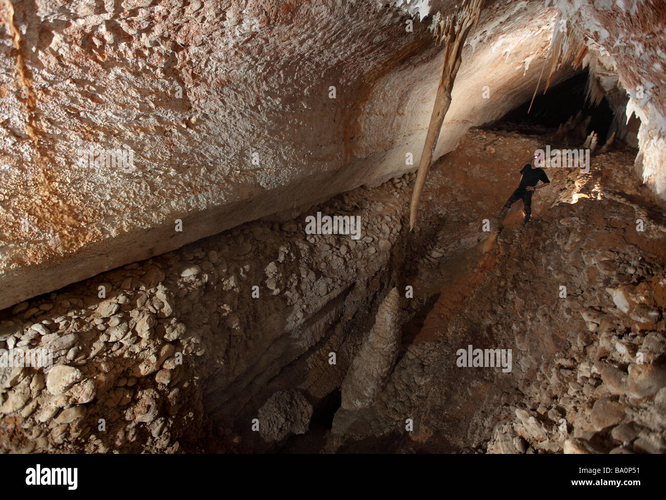 A British cave explorer admires this fascinating cave formation deep ...