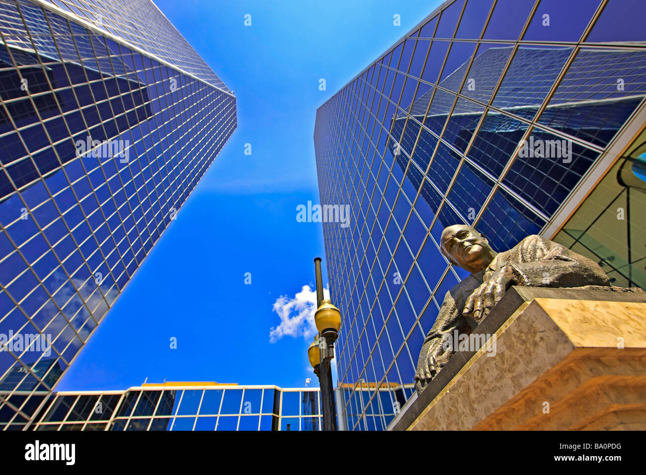 High rise building towers and statue of Frederick W Hill in the ...