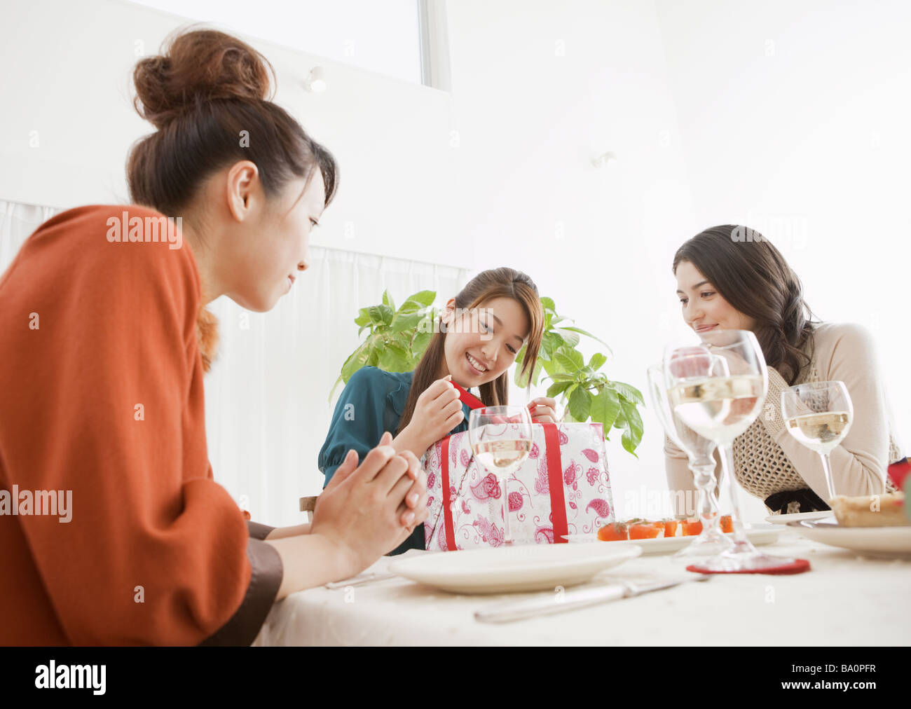 Woman opening a gift Stock Photo - Alamy