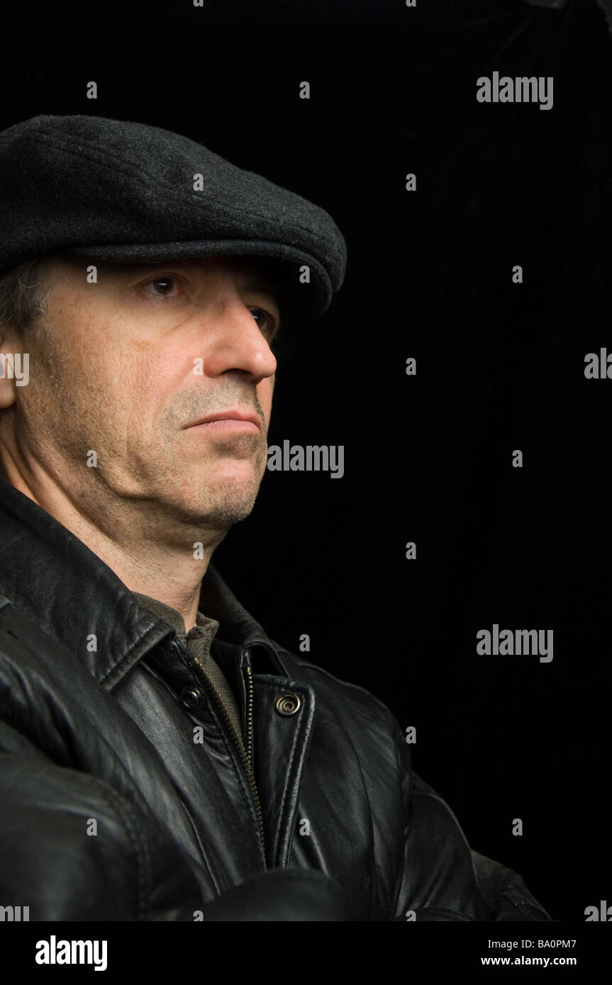 Tough looking man in a dark doorway Stock Photo - Alamy