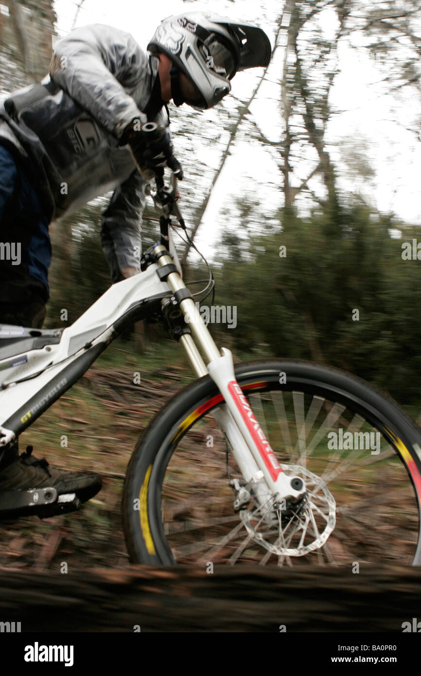 A downhill bike rider rides around a berm Stock Photo - Alamy