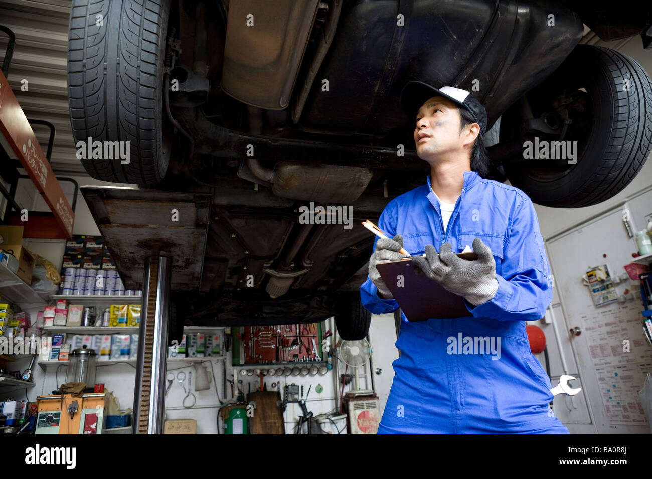 Mechanic checking car Stock Photo - Alamy