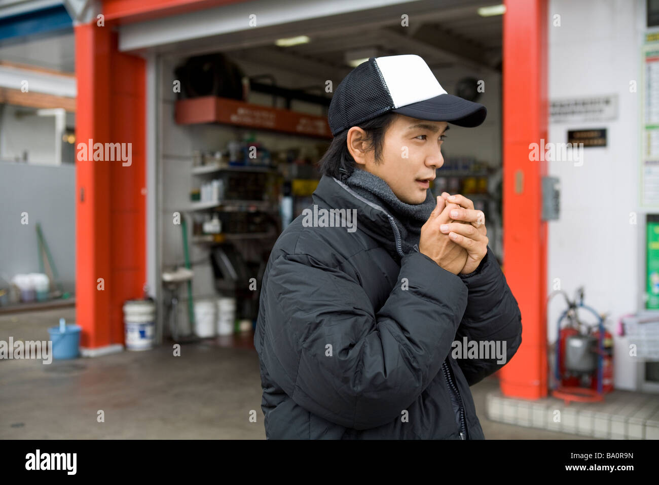 Gas station clerk wearing down jacket Stock Photo - Alamy