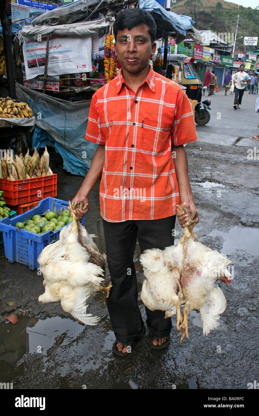 Young Indian Boy Carrying Chickens in Each Hand Through A Market Stock ...