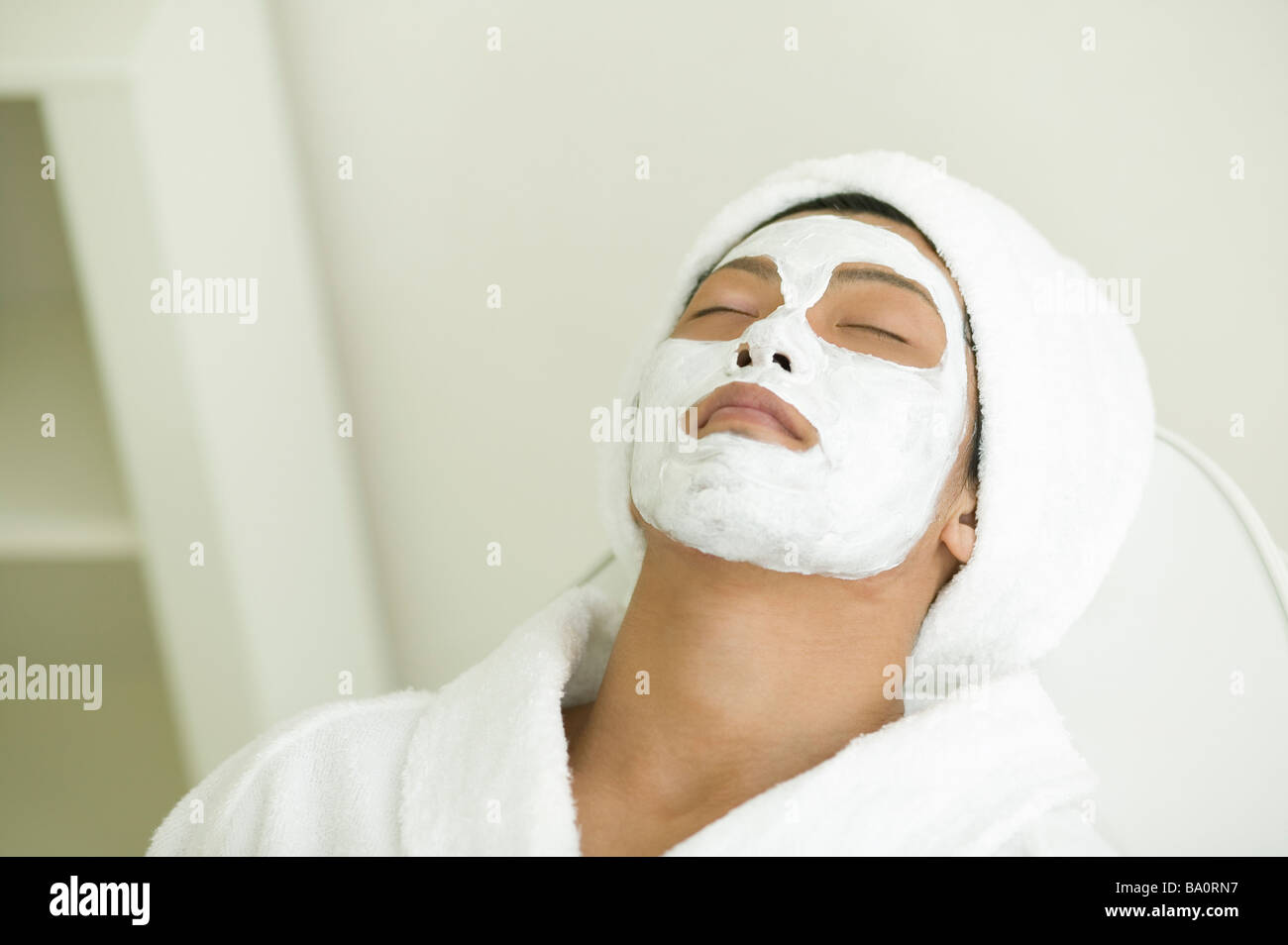 Young man receiving facial pack Stock Photo - Alamy
