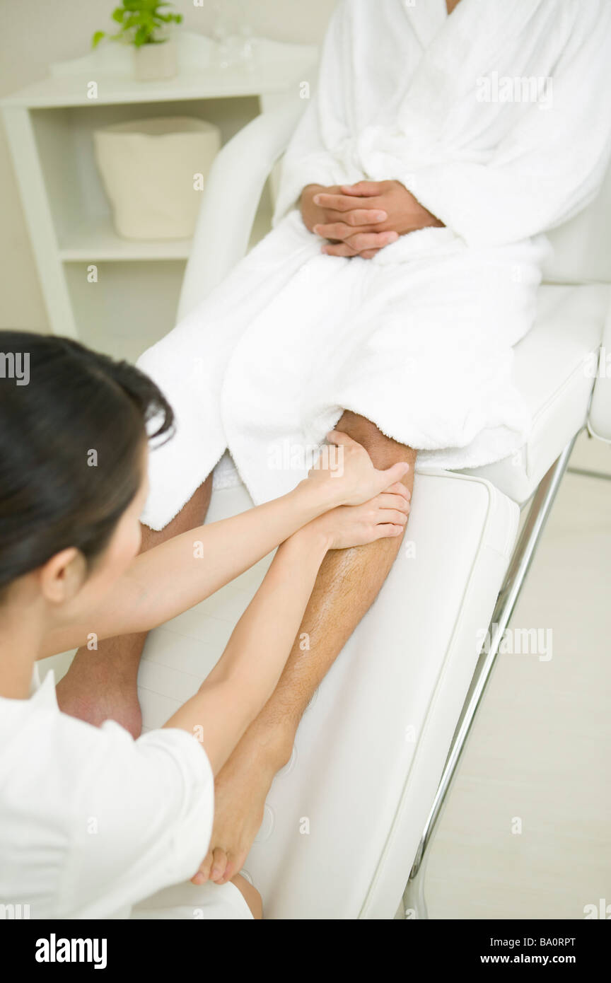 Massage therapist applying foot massage Stock Photo - Alamy