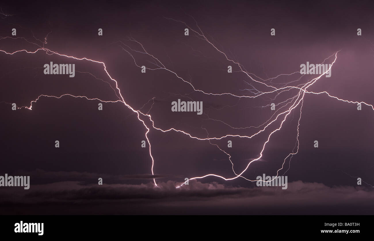 A large lightning bolt with multiple fingers extending between clouds ...