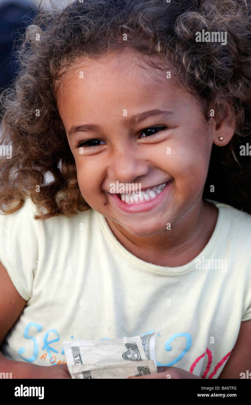 Happy Cuban girl holding pesos Stock Photo - Alamy