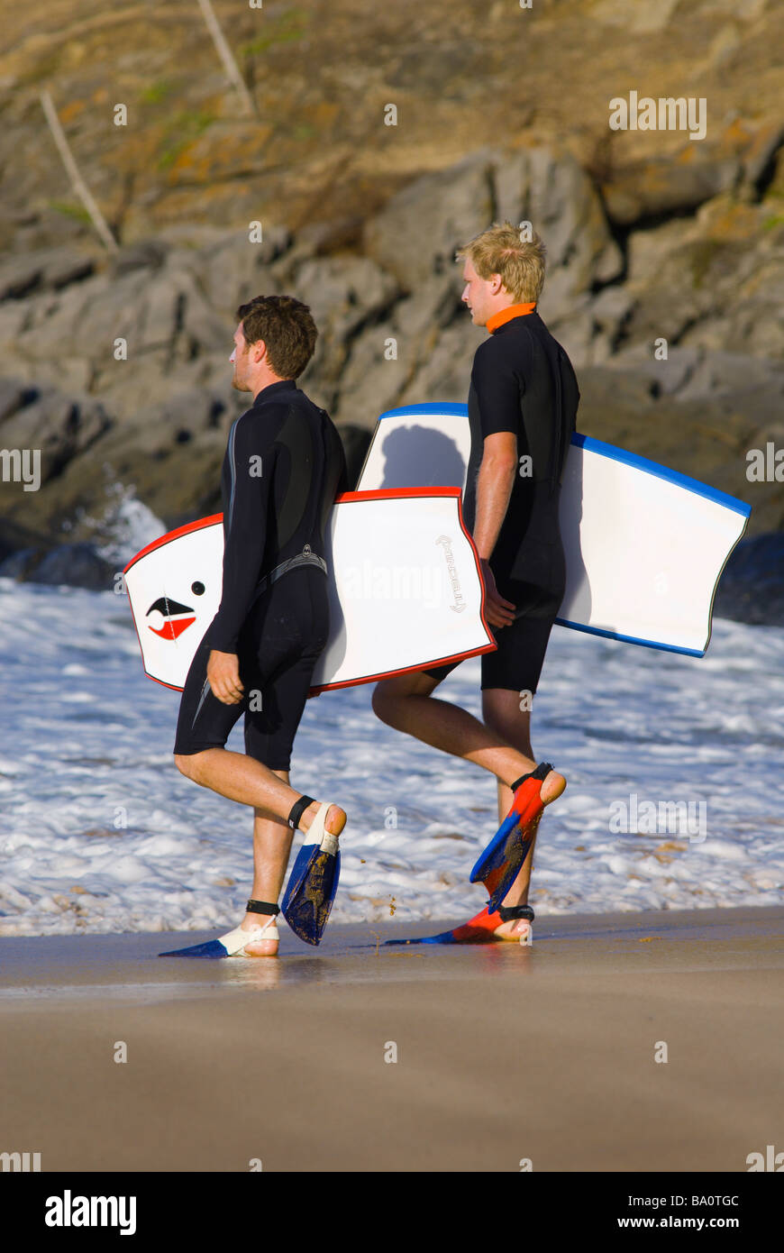 Two young male bodyboarders preparing to surf Stock Photo - Alamy