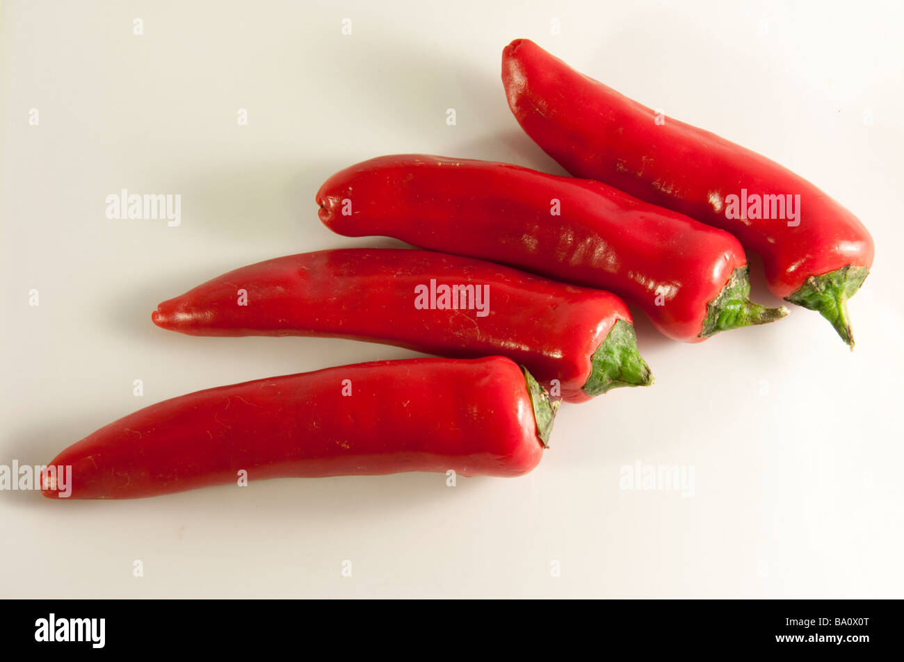 Four red chillies Stock Photo - Alamy