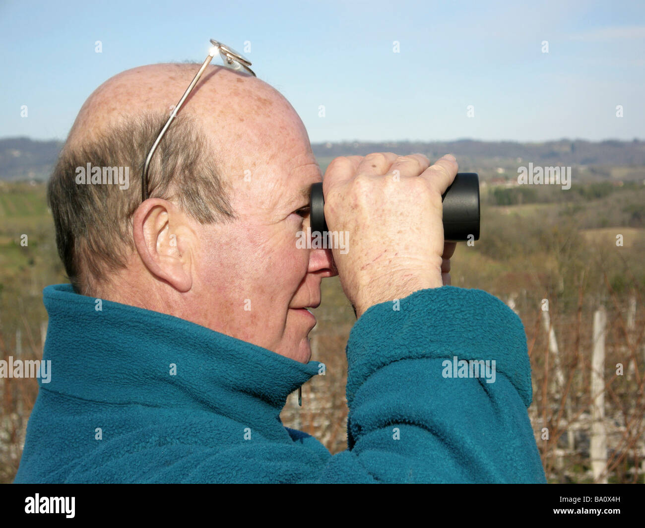 Man looking for something through binoculars in the countryside Stock ...