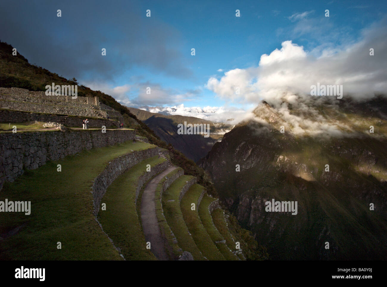 PERU MACHU PICCHU Sunrise hitting the Inca Terraces of Machu Picchu ...