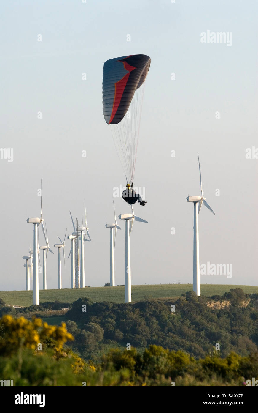 paraglider flying in front of wind powered turbines Stock Photo - Alamy