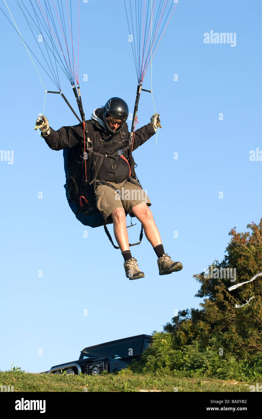 Paraglider pilot coming into land Stock Photo - Alamy