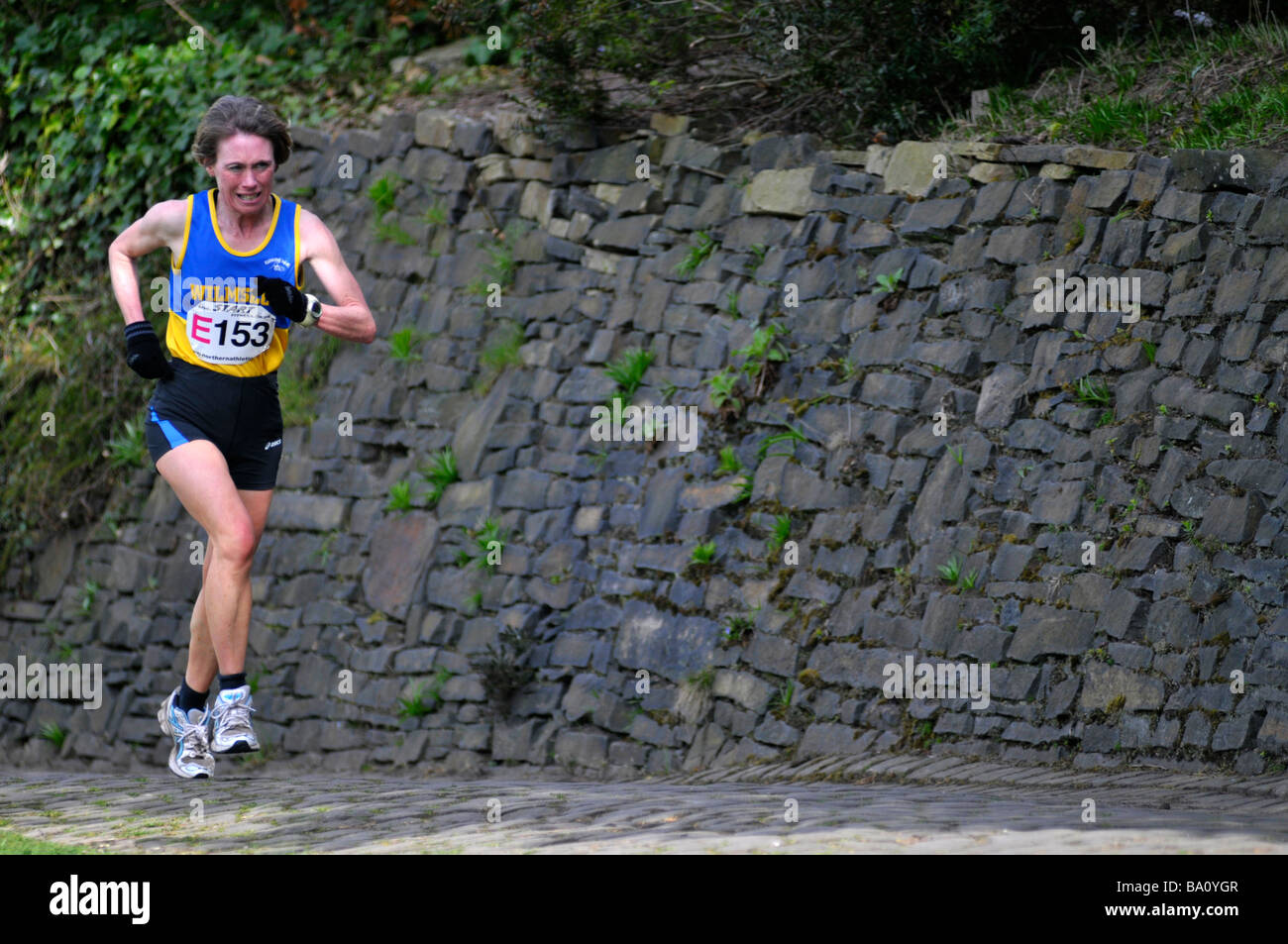 female runner in road relay Stock Photo - Alamy